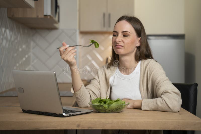 A Thoughtful Young Woman Eats a Salad and Experiences a Lack of ... A Thoughtful Young Woman Eats a Salad and Experiences a Lack of ...