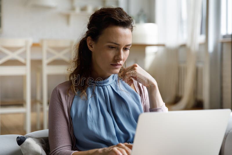 Thoughtful Young Woman Looking at Computer Screen. Stock Image - Image ...