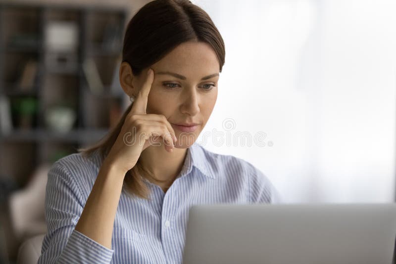 Thoughtful Young Woman Read Document on Computer Screen at Workplace ...