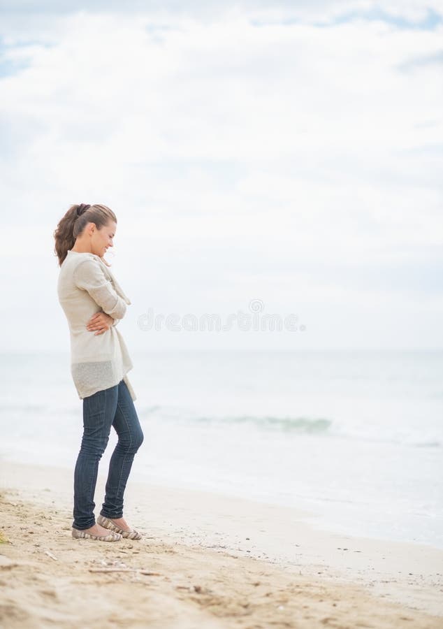 Thoughtful Young Woman Standing on Cold Beach Stock Image - Image of ...