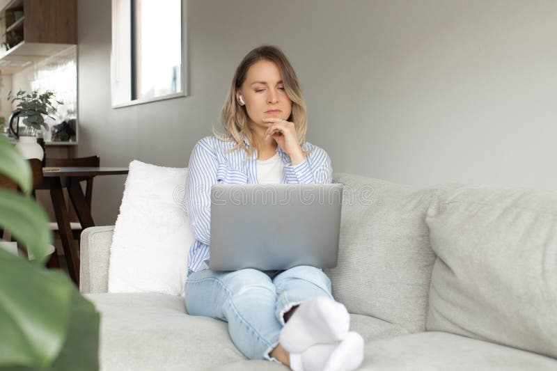 Thoughtful Young Woman Using Laptop at Home for Work or Study Stock ...