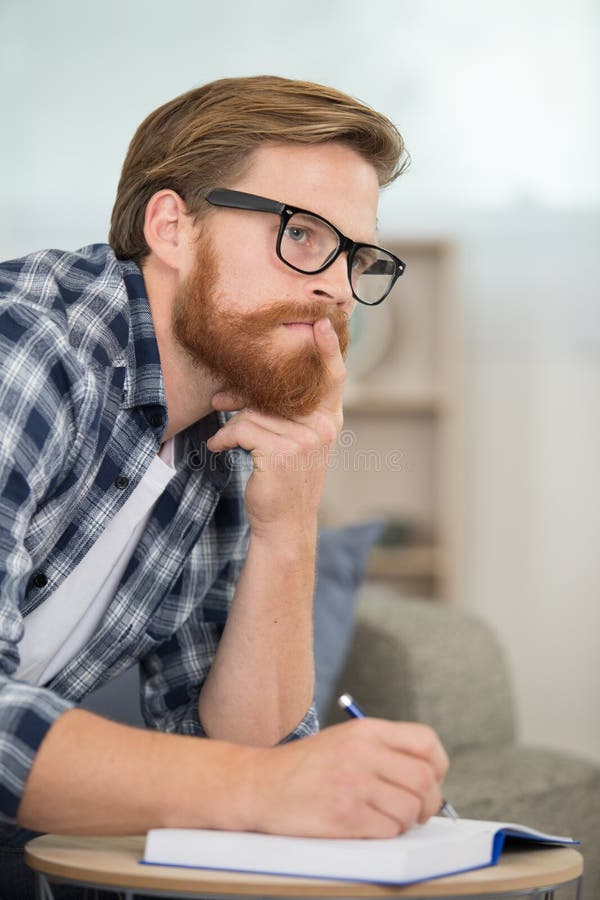 Thoutful Young Man Writing on Book Stock Photo - Image of learning ...