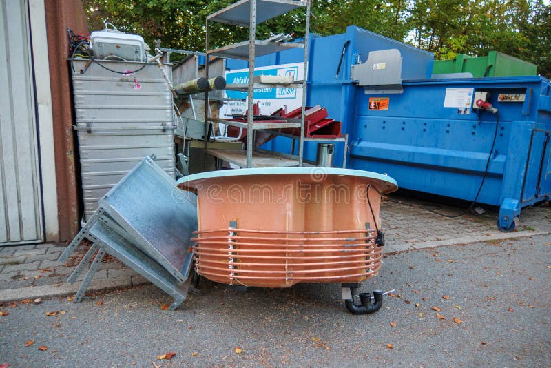 On Thr Garbage Lies a Discarded Bathtub Surrounded with Copper Pipes ...