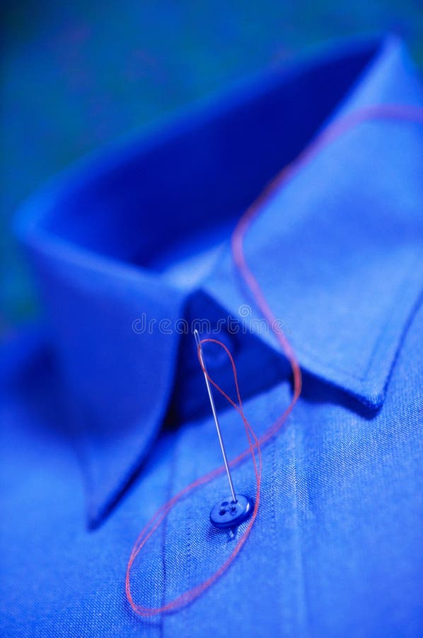 Red Thread and Needle on Blue Shirt Stock Photo - Image of needle ...