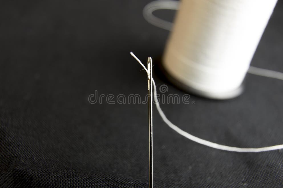 Thread in Needle Eye with Spool Stock Photo - Image of needle, threaded ...