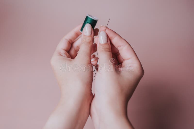 Thread and needle in hand stock image. Image of elderly - 230671079