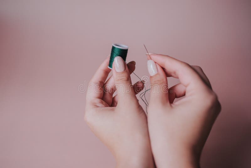 Thread and needle in hand stock photo. Image of hole - 230671080