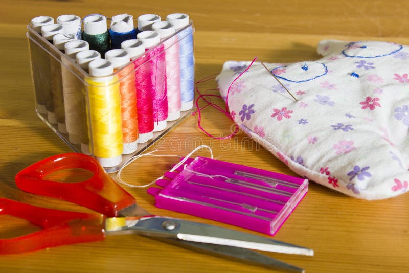 Thread, Needles, Scissors and a Toy on the Table. Stock Image - Image ...