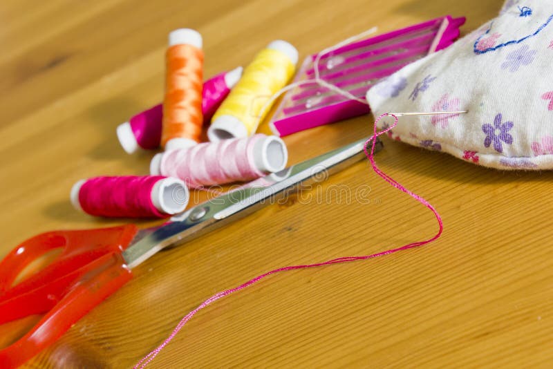 Thread, Needles, Scissors and a Toy on the Table. Stock Image - Image ...