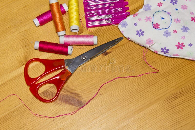 Thread, Needles, Scissors and a Toy on the Table. Stock Image - Image ...