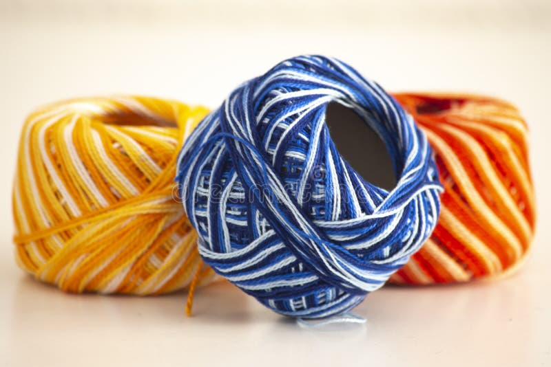 Three Thread Spools Red Orange and Blue Stock Photo - Image of hand ...