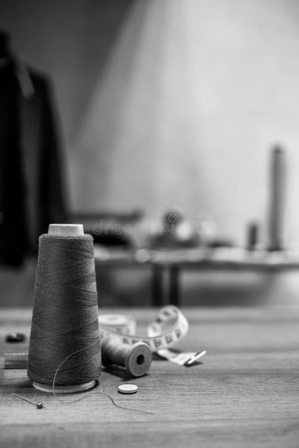 Thread Spool and Needle with Sewing Tools on Table. Concept of Clothes ...