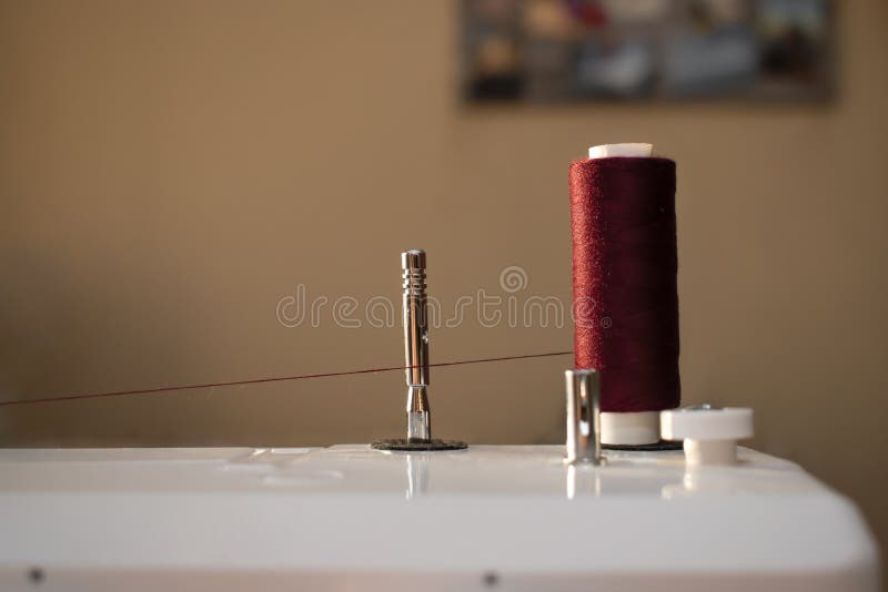 Thread Spool on a Sewing Machine Close-up on the Brown Backgound Stock ...