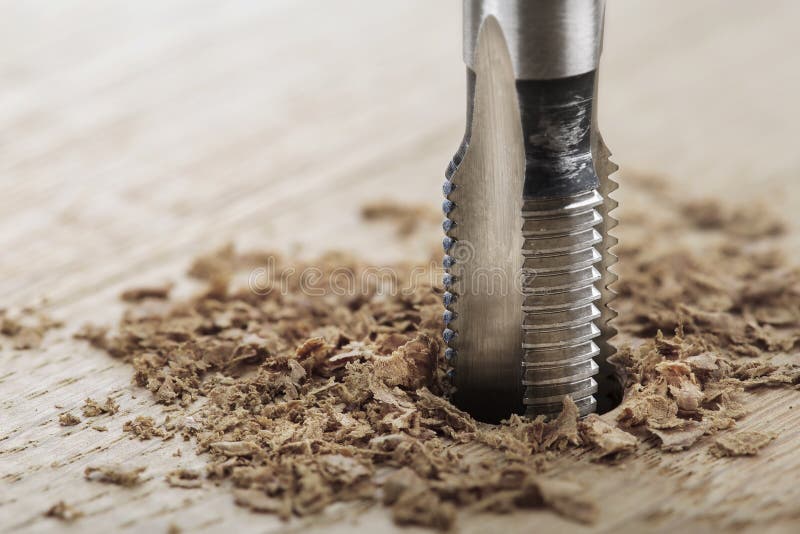 Thread Tap Drill Cutting Hole in Wooden Plate. Working Cutter Stock ...