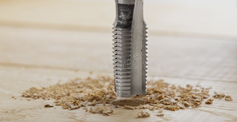 Thread Tap Drill Cutting Hole in Wooden Plate. Working Cutter Stock ...