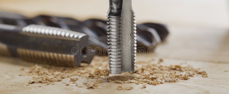 Thread Tap Drill Cutting Hole in Wooden Plate. Working Cutter Stock ...