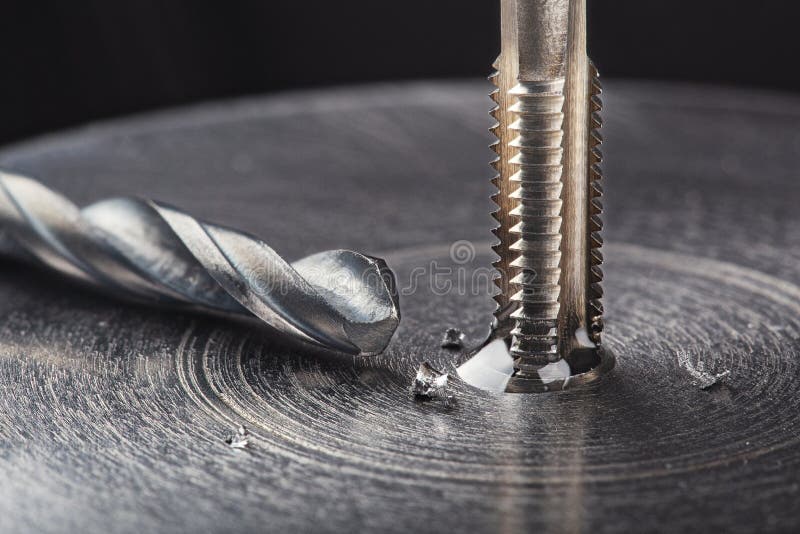 Thread Tap Drill Steel Billet with Drill Bit on Background. Working ...