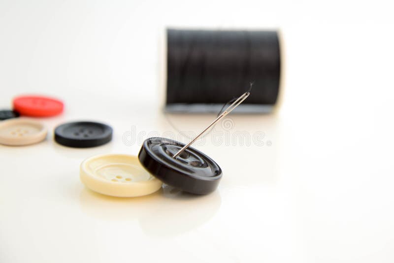Black Spool of Thread, Needle and Butons Stock Image - Image of thread ...