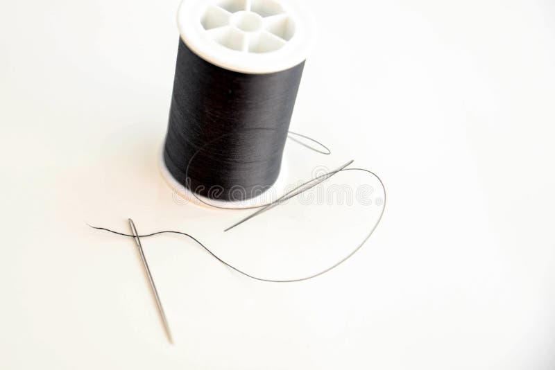 Black Spool of Thread, Needle, and Black and White Buttons Stock Photo ...