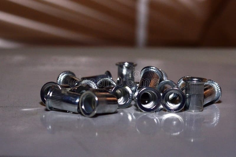 Threaded Rivets Lie on a Metal Surface Stock Image - Image of pitch ...