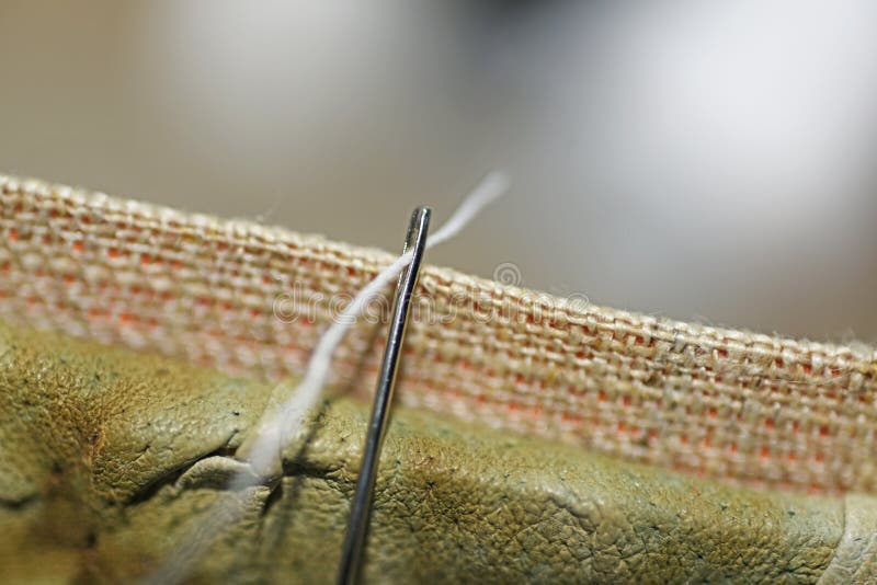 Threading a needle thread. stock image. Image of design - 83947217
