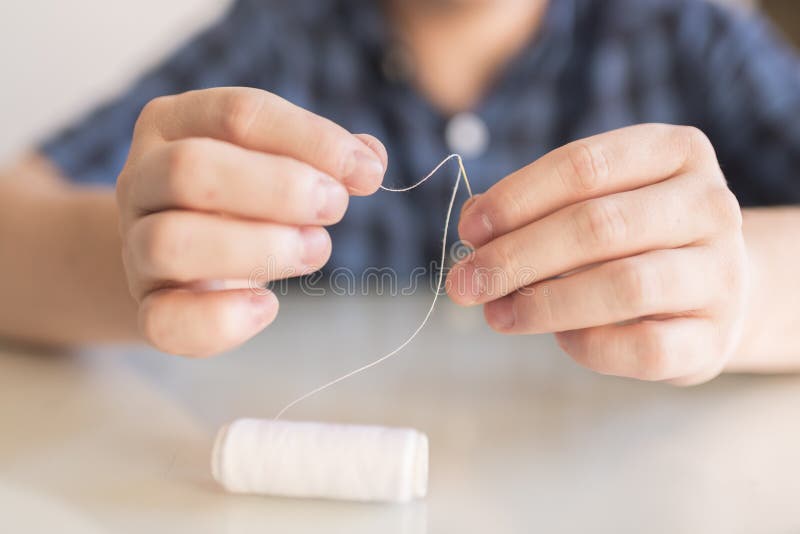 Threading a White Thread into a Needle. Making a Homemade Protective ...