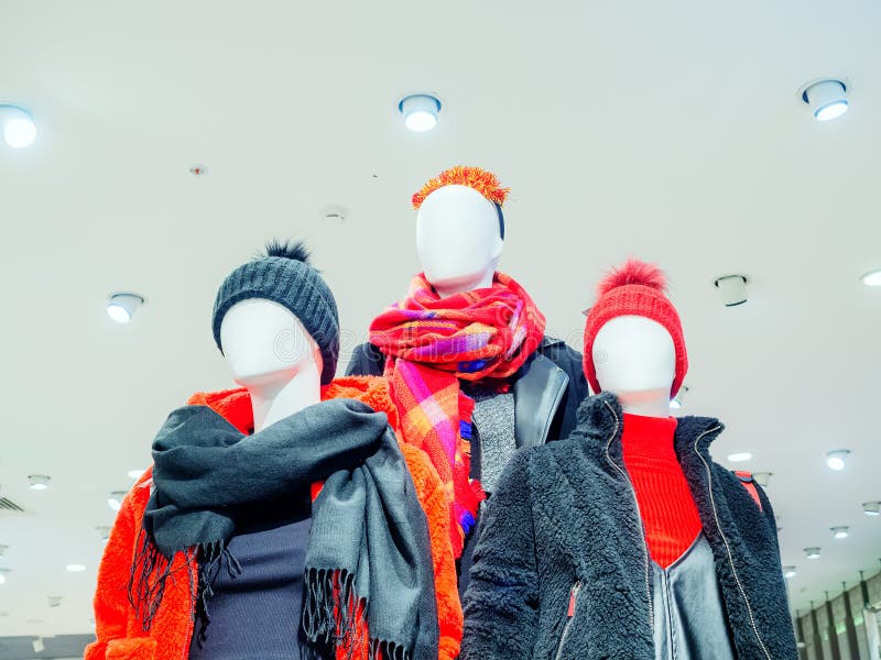Three Abstract Mannequins in Winter Clothes. Photo Below Against the ...