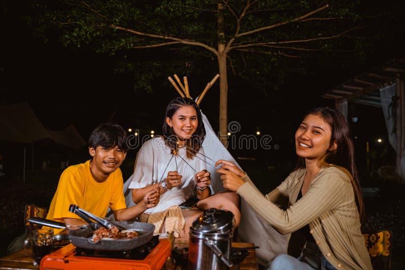 Three Adults Playing the Fireworks Together Stock Image - Image of ...