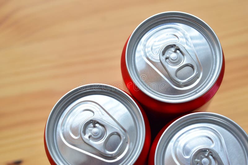 Three Aluminium Red Cans of Soft Drink Put on Brown Wooden Table Stock ...
