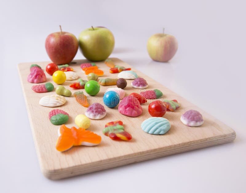 Three apples and candy stock photo. Image of dessert - 69740722