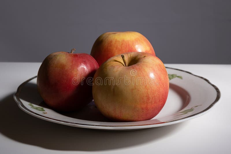 Three Apples on a Plate on a Table in the Kitchen. Low Key Stock Image ...