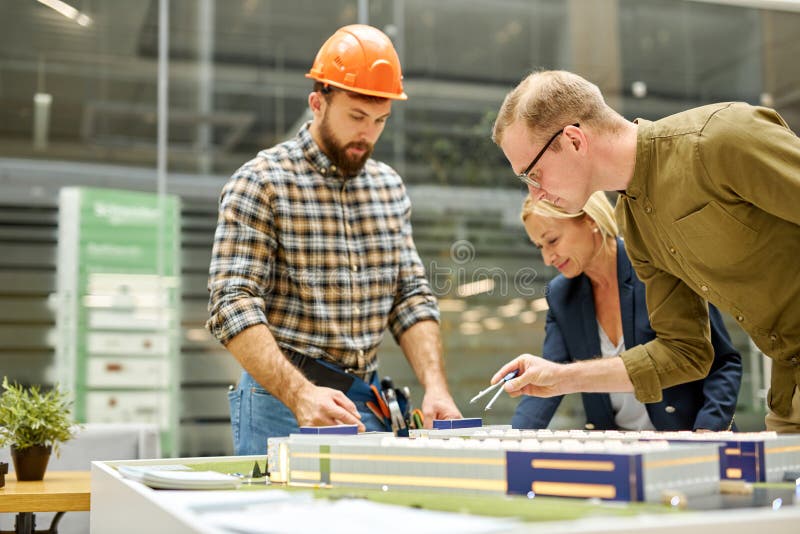 Three Architects Concentrated on Work Stock Image - Image of holding ...