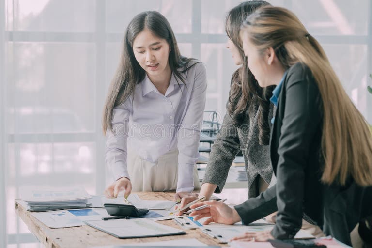 Three Asian Business Women Making Money from Document Graphs, Analyzing ...