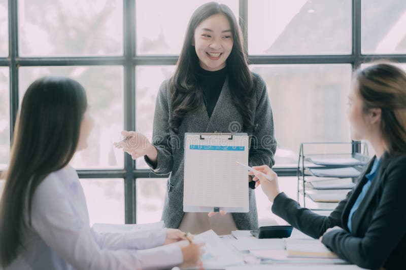 Three Asian Business Women Making Money from Document Graphs, Analyzing ...