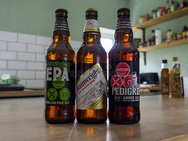 Three Assorted Beer Bottles Placed on a Kitchen Counter Editorial Image ...