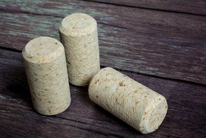 Three Assorted Cork Stoppers on a Old Barn Board Floor Stock Photo ...