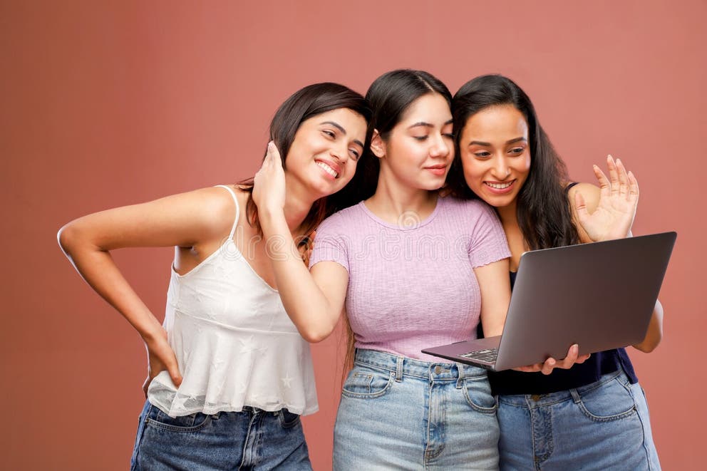 Three Attractive Models Looking at Laptop and Browsing the Internet ...