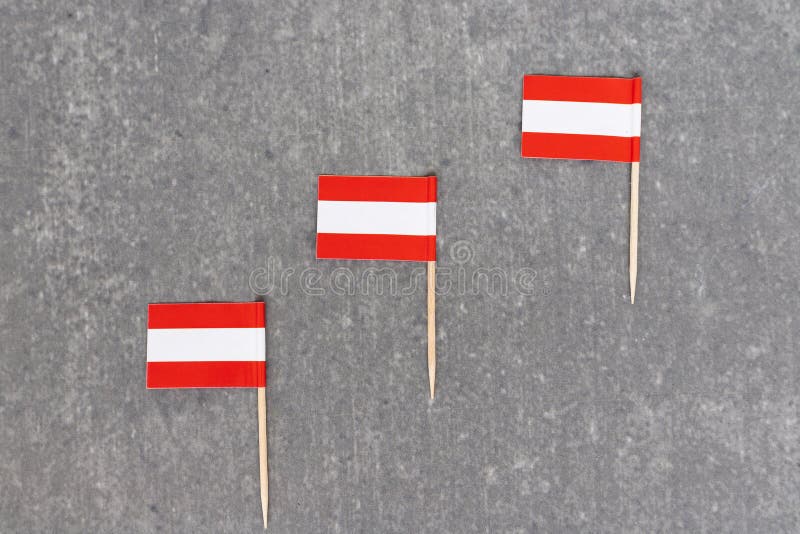 Three Austria Mini Flags in Diagonal Formation on Grey Background Stock ...