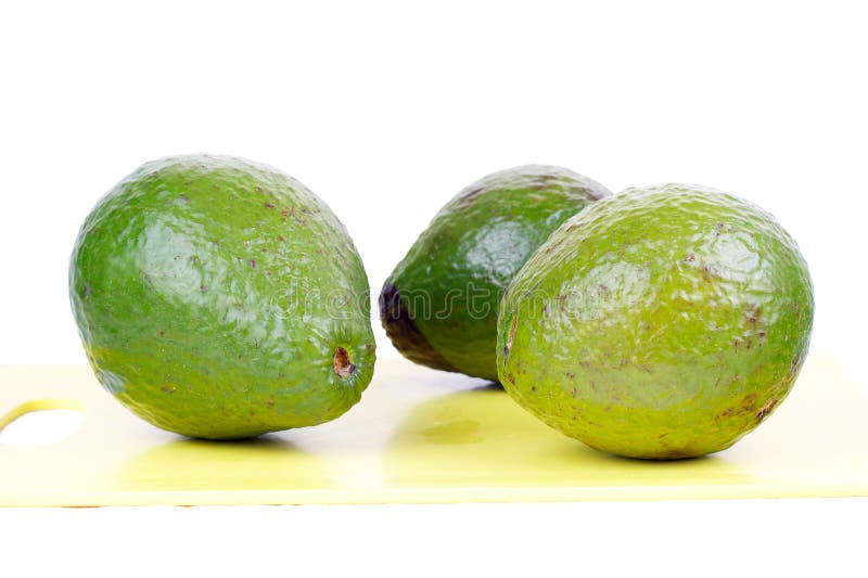 Three Avocado on Yellow Board Stock Photo - Image of vegetables, green ...