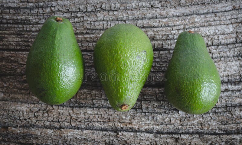 Three Avocados on Rustic Table. Top View Stock Image - Image of market ...