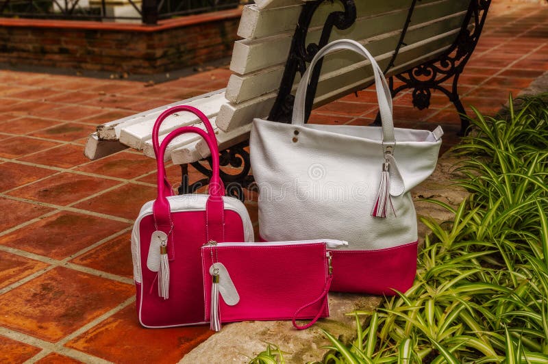 Three Bags Sit on the Ground in Front of a Bench Stock Photo - Image of ...