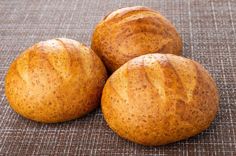 Three Baked Buns on Brown Mat Stock Photo - Image of baked, closeup ...
