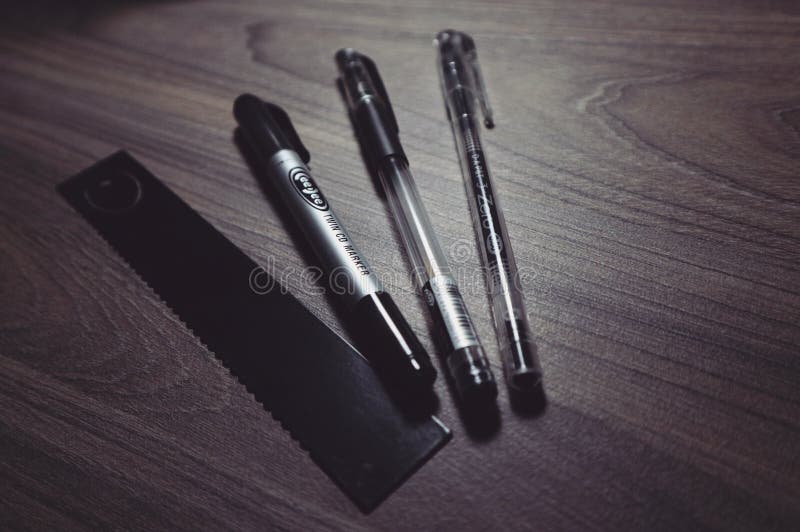 Three Ballpoint Pens And Black Ruler On Beige Wooden Surface Picture ...