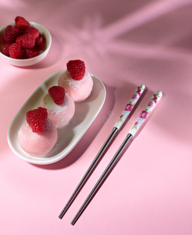 Three Balls Of Raspberry Mochi Decorated With Berries On A Pink Background With Beautiful