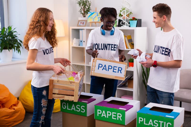 Three Beaming Teenagers Feeling Responsible while Sorting Waste Stock ...