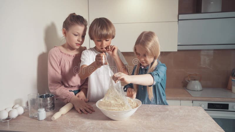 Three Beautiful Children Help in the Kitchen and Prepare the Dough ...
