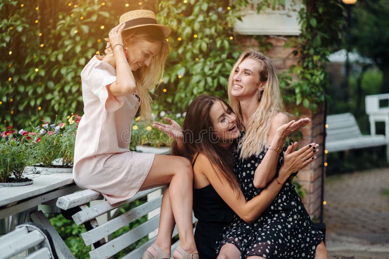 Three girls on the bench stock photo. Image of beautiful - 139914026