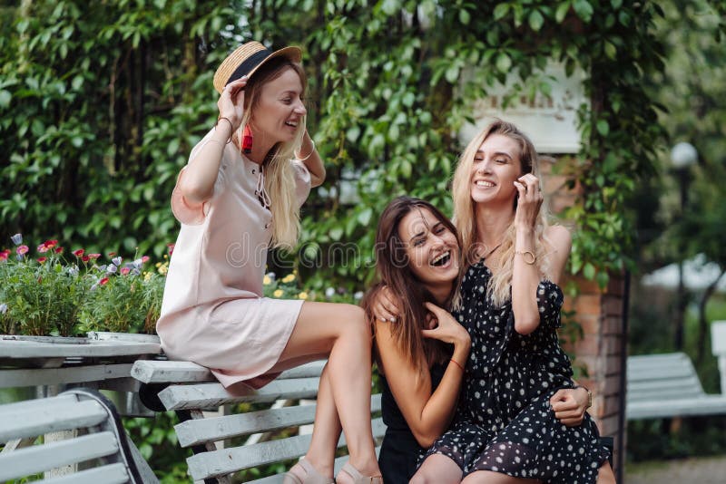 Three girls on the bench stock image. Image of holiday - 141664505