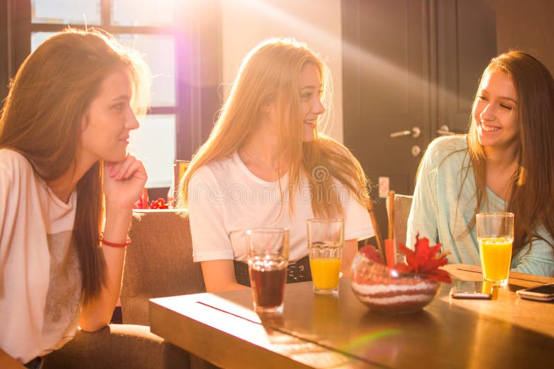 Three Beautiful Girls Talking in a Cafe Bar. Stock Photo - Image of ...