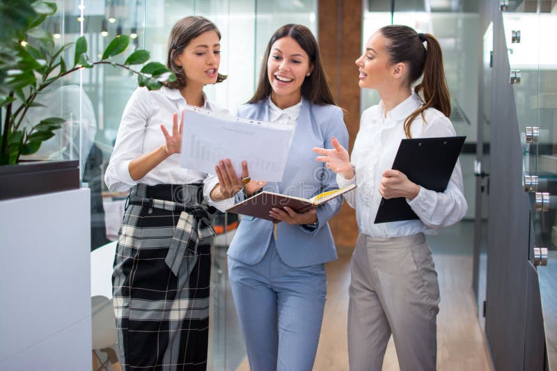 Three Beautiful Young Business Woman Discussing Documents in Office ...